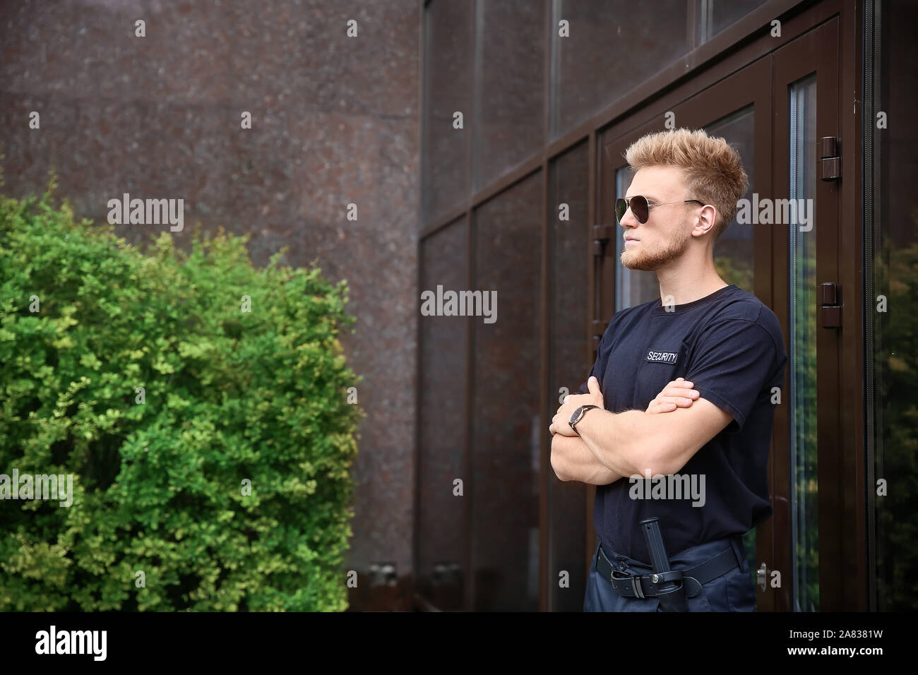 Handsome male security guard outdoors Stock Photo - Alamy