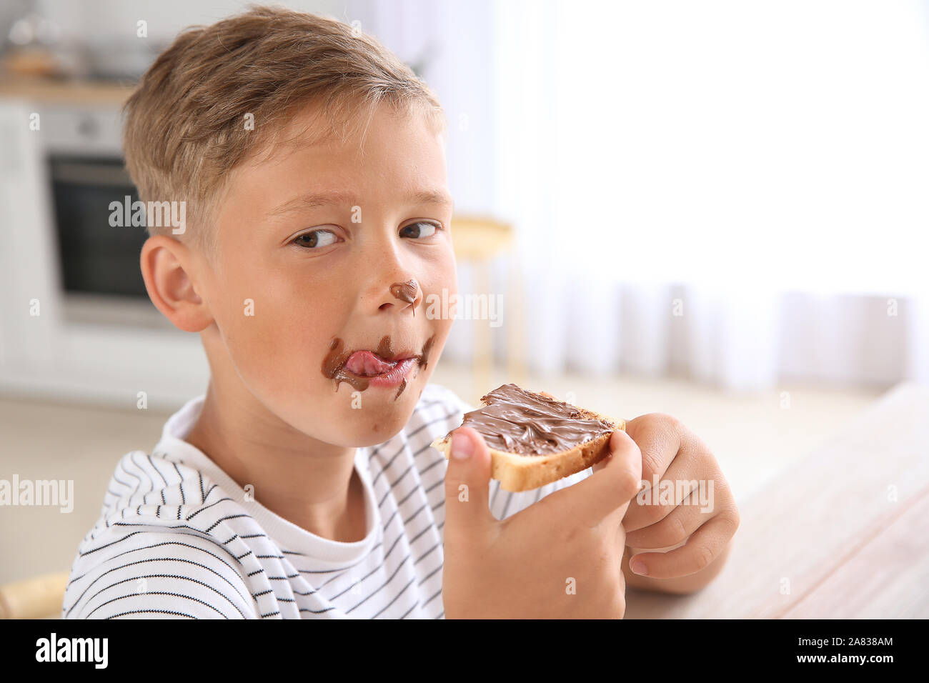 Boy eating bread spread hi-res stock photography and images - Alamy