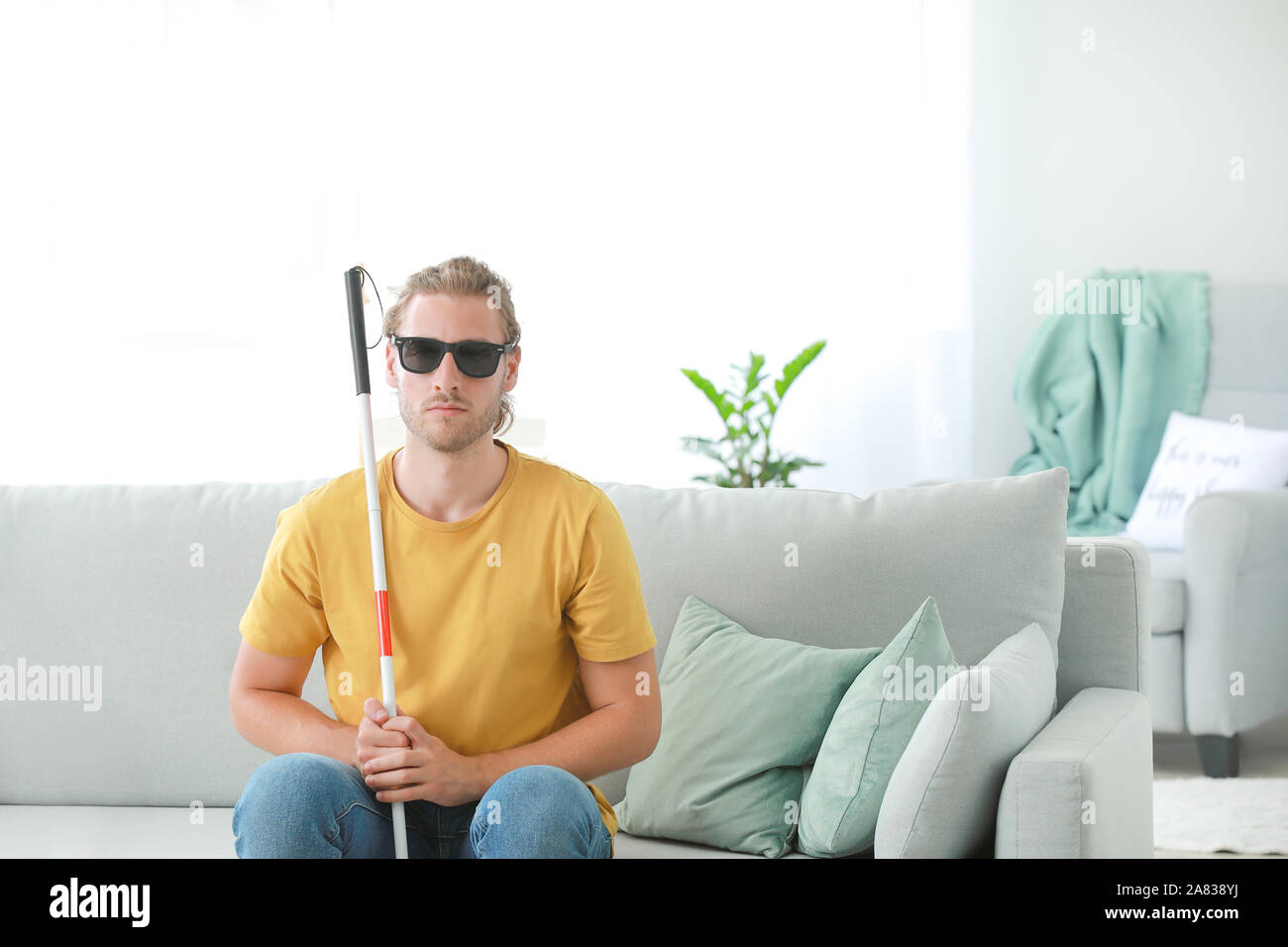 Blind young man at home Stock Photo - Alamy
