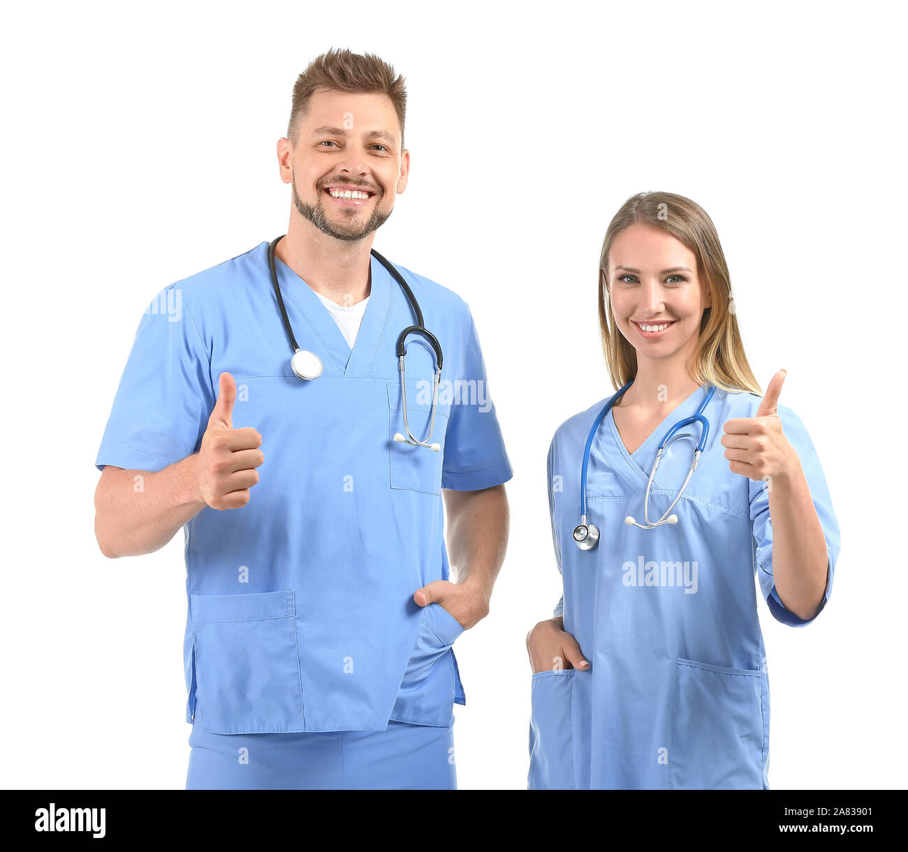 Male and female nurses showing thumb-up on white background Stock Photo ...
