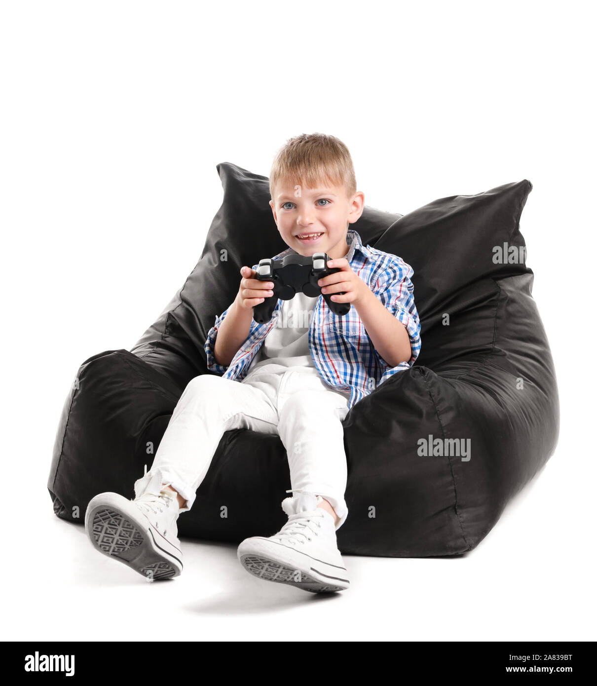 Cute little boy playing video games on white background Stock Photo - Alamy