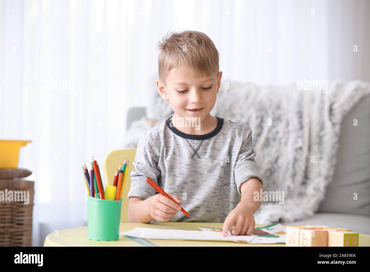 Cute little boy drawing picture at home Stock Photo - Alamy