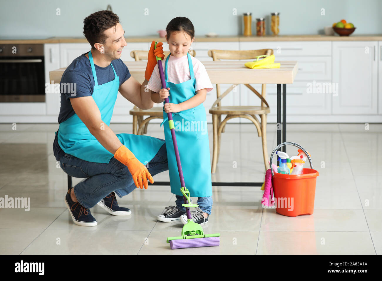 Father and daughter cleaning kitchen together Stock Photo - Alamy