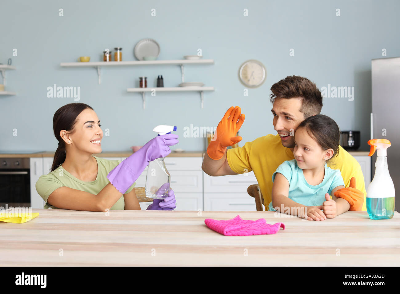 Happy family cleaning kitchen together Stock Photo - Alamy