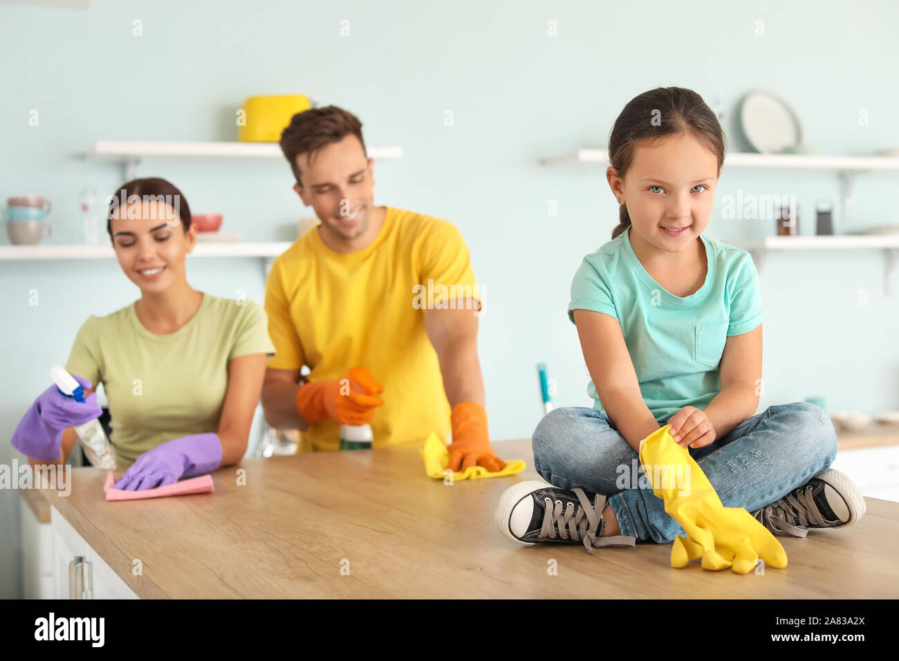 Happy family cleaning kitchen together Stock Photo - Alamy