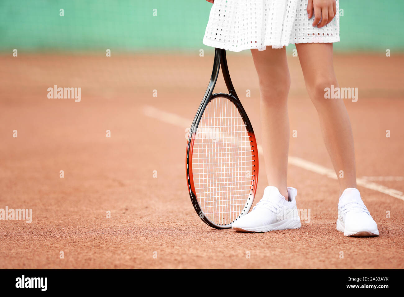 Little girl playing tennis on court Stock Photo - Alamy