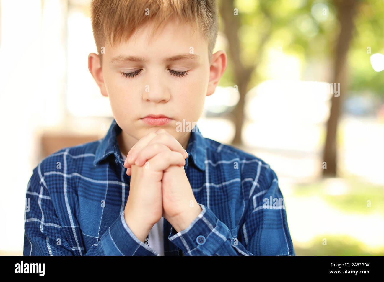 Boy praying outdoors hi-res stock photography and images - Alamy
