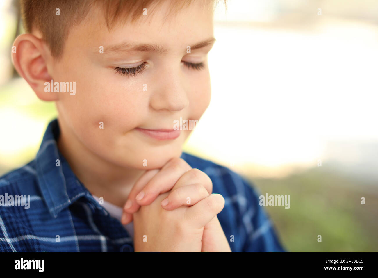 Boy praying outdoors hi-res stock photography and images - Alamy