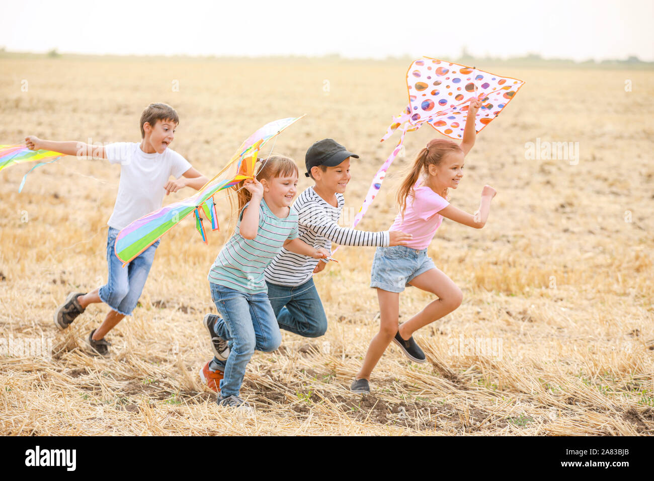 Little children flying kites outdoors Stock Photo - Alamy