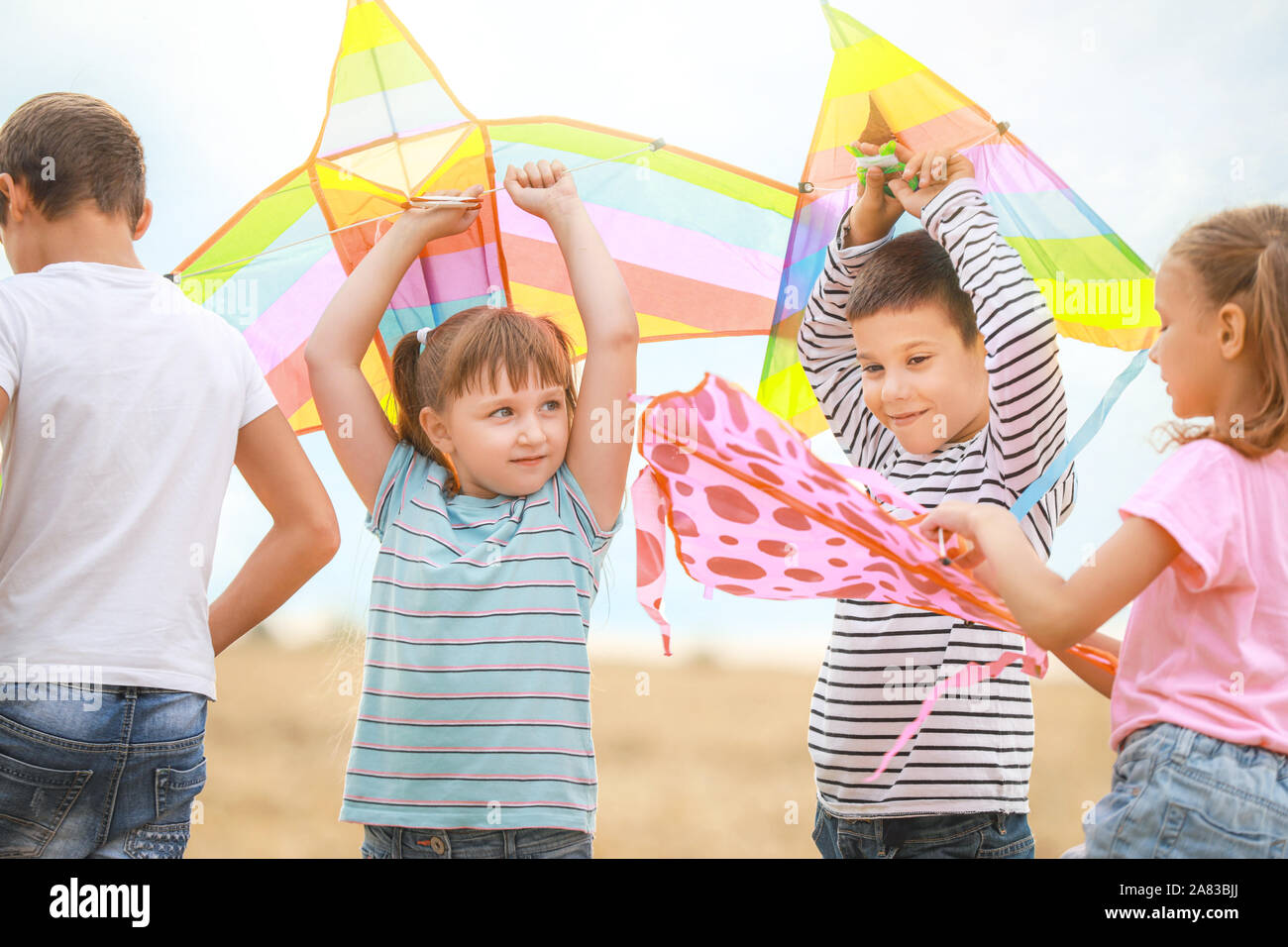 Little children flying kites outdoors Stock Photo - Alamy