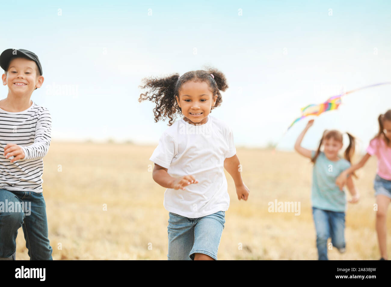 Little children playing in field Stock Photo - Alamy