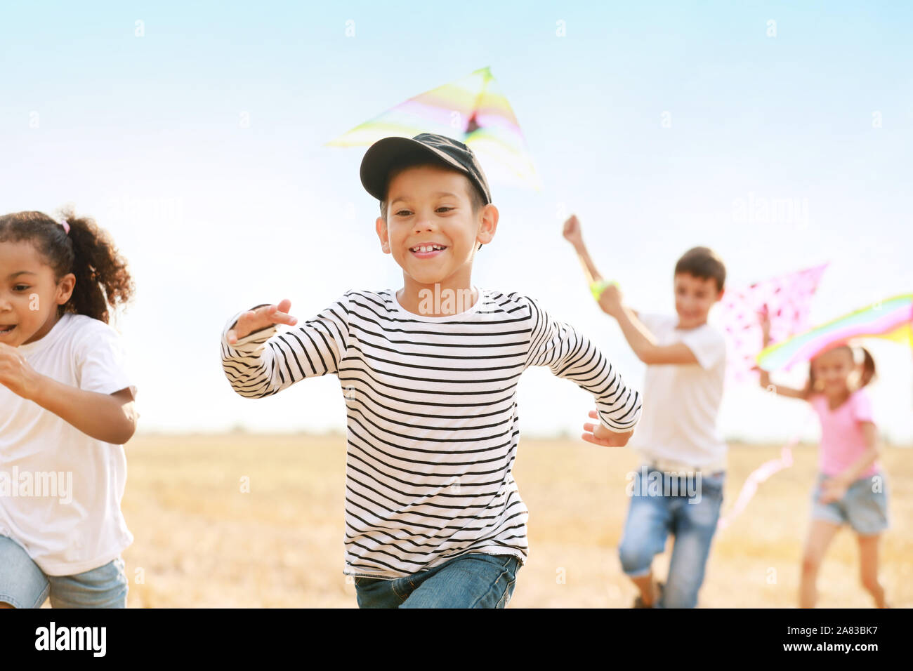 Little children flying kites outdoors Stock Photo - Alamy