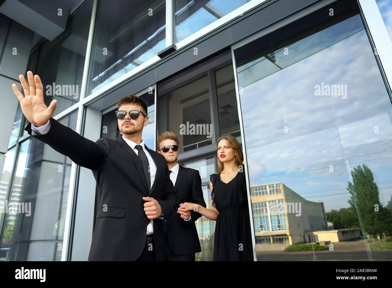 Famous celebrity with bodyguards outdoors Stock Photo - Alamy
