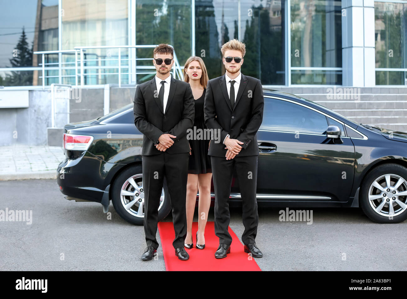 Famous celebrity with bodyguards near car outdoors Stock Photo - Alamy