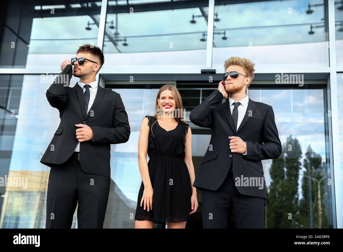 Famous celebrity with bodyguards outdoors Stock Photo - Alamy