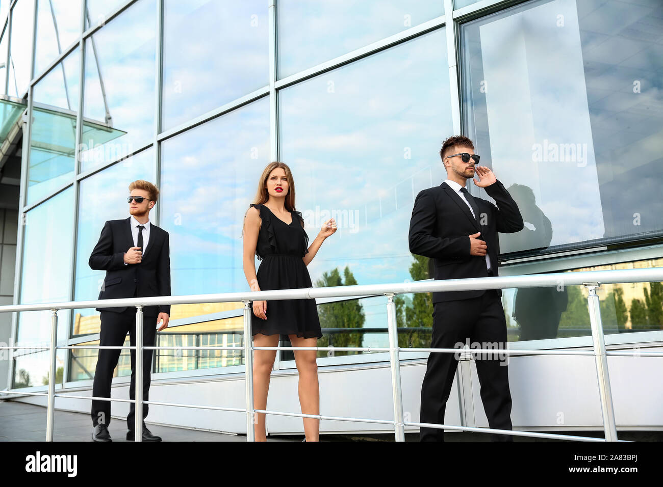 Famous celebrity with bodyguards outdoors Stock Photo - Alamy