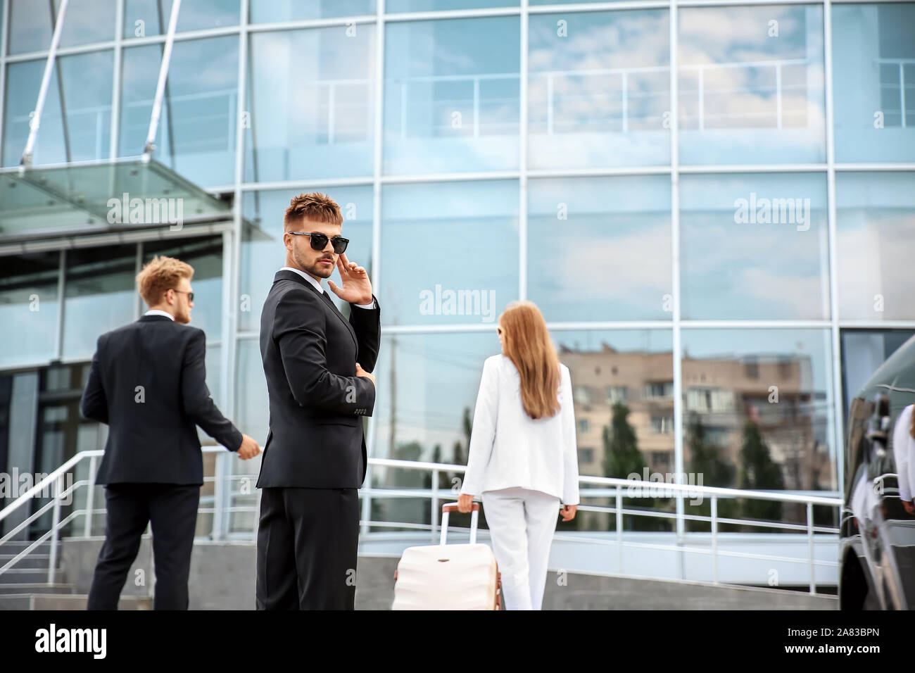 Young celebrity with bodyguards in airport Stock Photo - Alamy