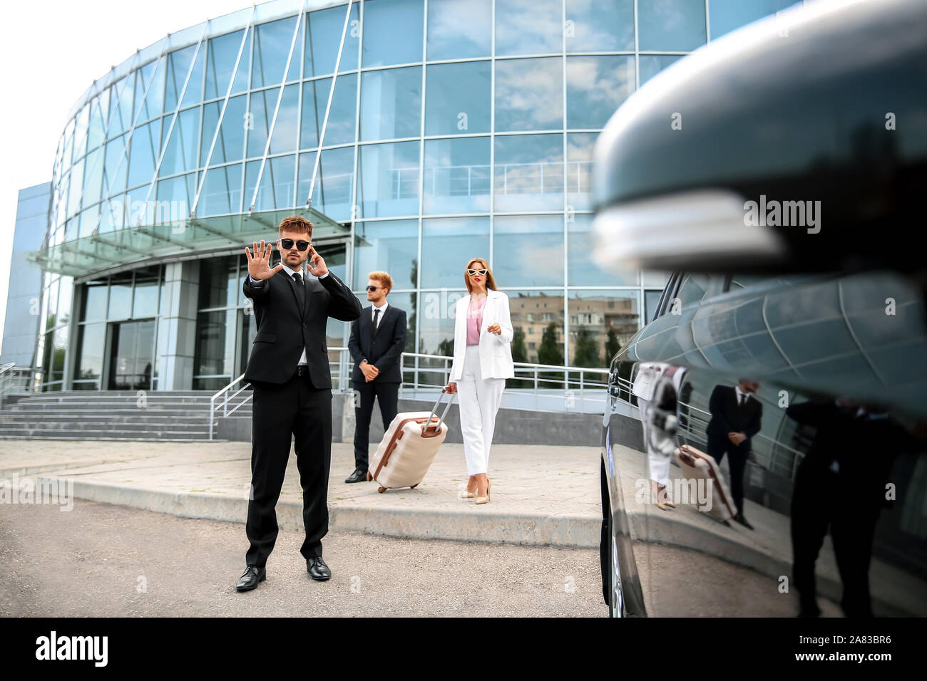 Young celebrity with bodyguards in airport Stock Photo - Alamy