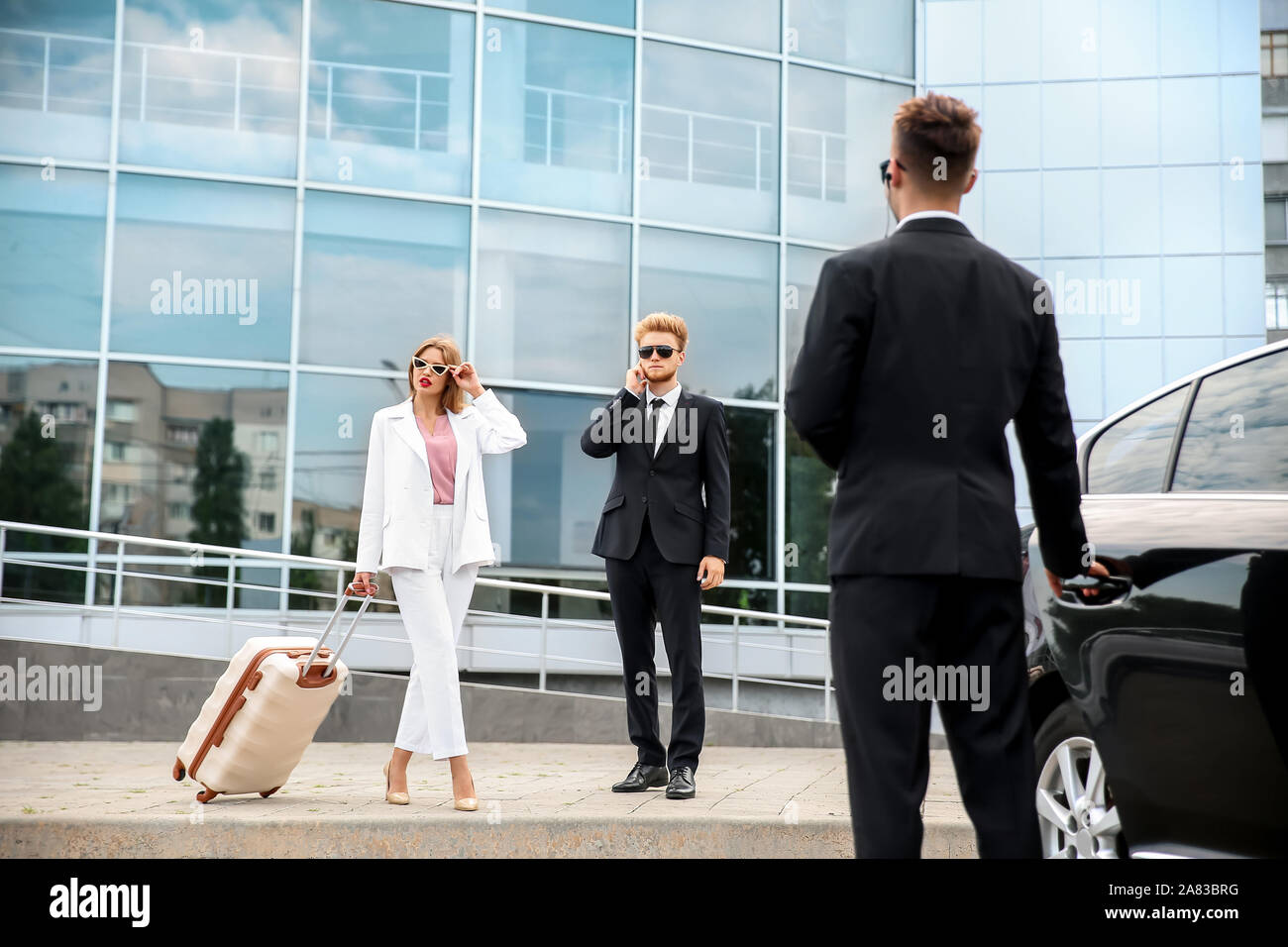 Young celebrity with bodyguards in airport Stock Photo - Alamy
