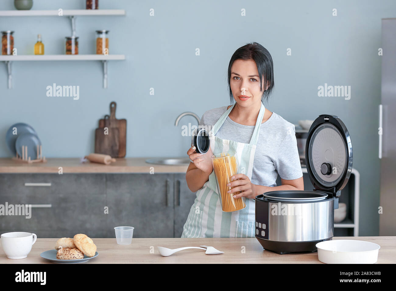 Beautiful woman multi cooker hi-res stock photography and images - Alamy