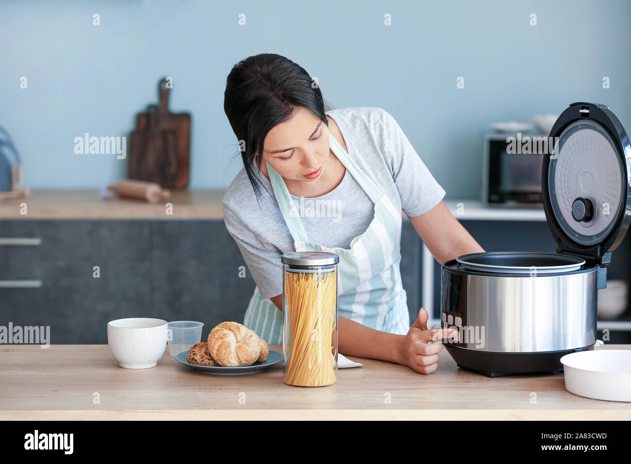 Beautiful woman multi cooker hi-res stock photography and images - Alamy
