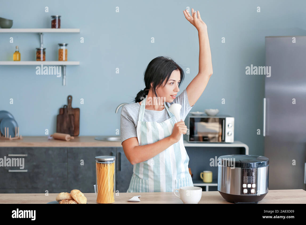 Beautiful woman multi cooker hi-res stock photography and images - Alamy