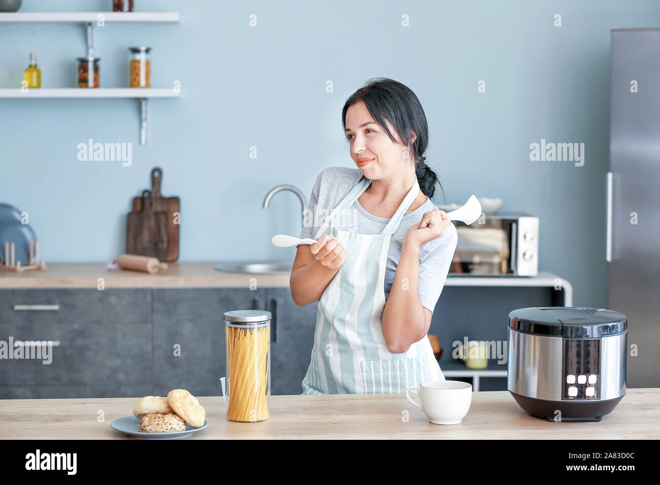 Beautiful woman multi cooker hi-res stock photography and images - Alamy