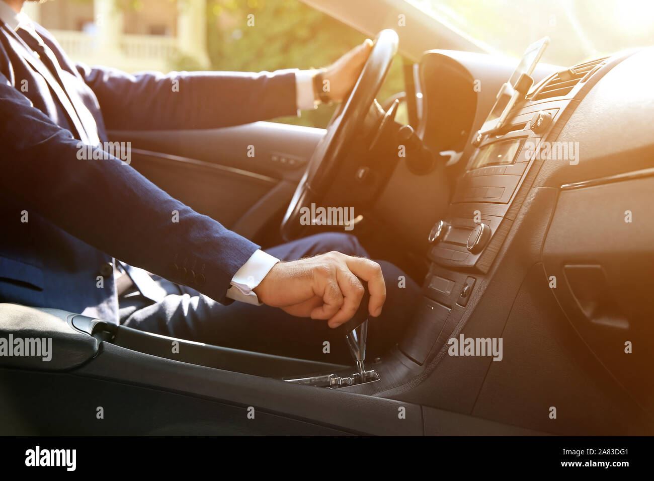 Successful businessman driving modern car Stock Photo - Alamy