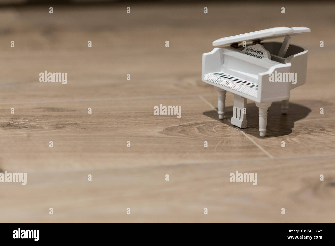 White tiny toy piano with great keyboard macro still isolated on a ...