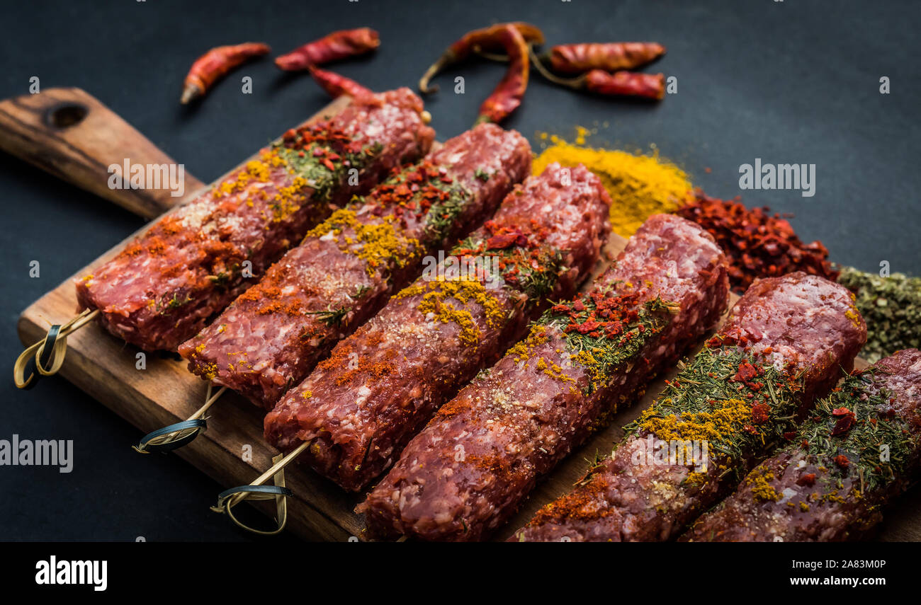 Raw kebab with spices Stock Photo - Alamy