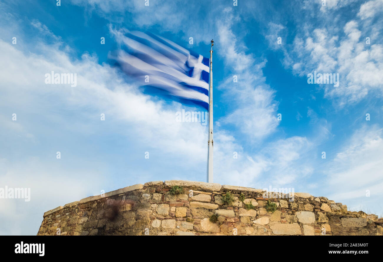 Greek flag waving against blue sky Stock Photo - Alamy