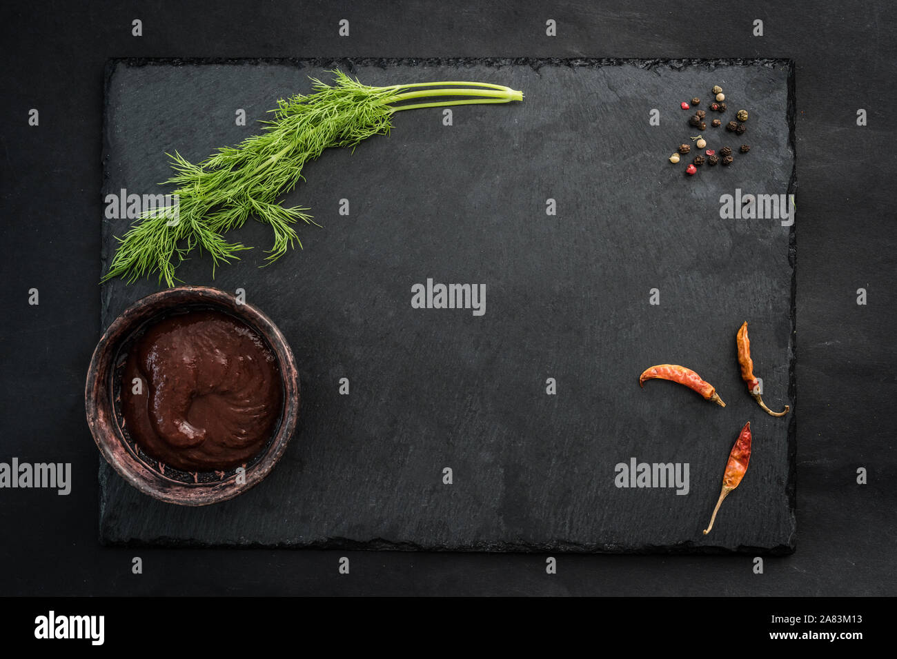 Black slate board with spices Stock Photo - Alamy