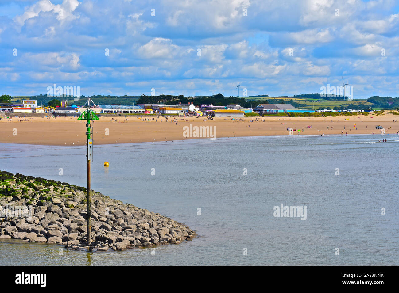 A view of Sandy Bay Porthcawl in Summer. People on sandy beach with ...