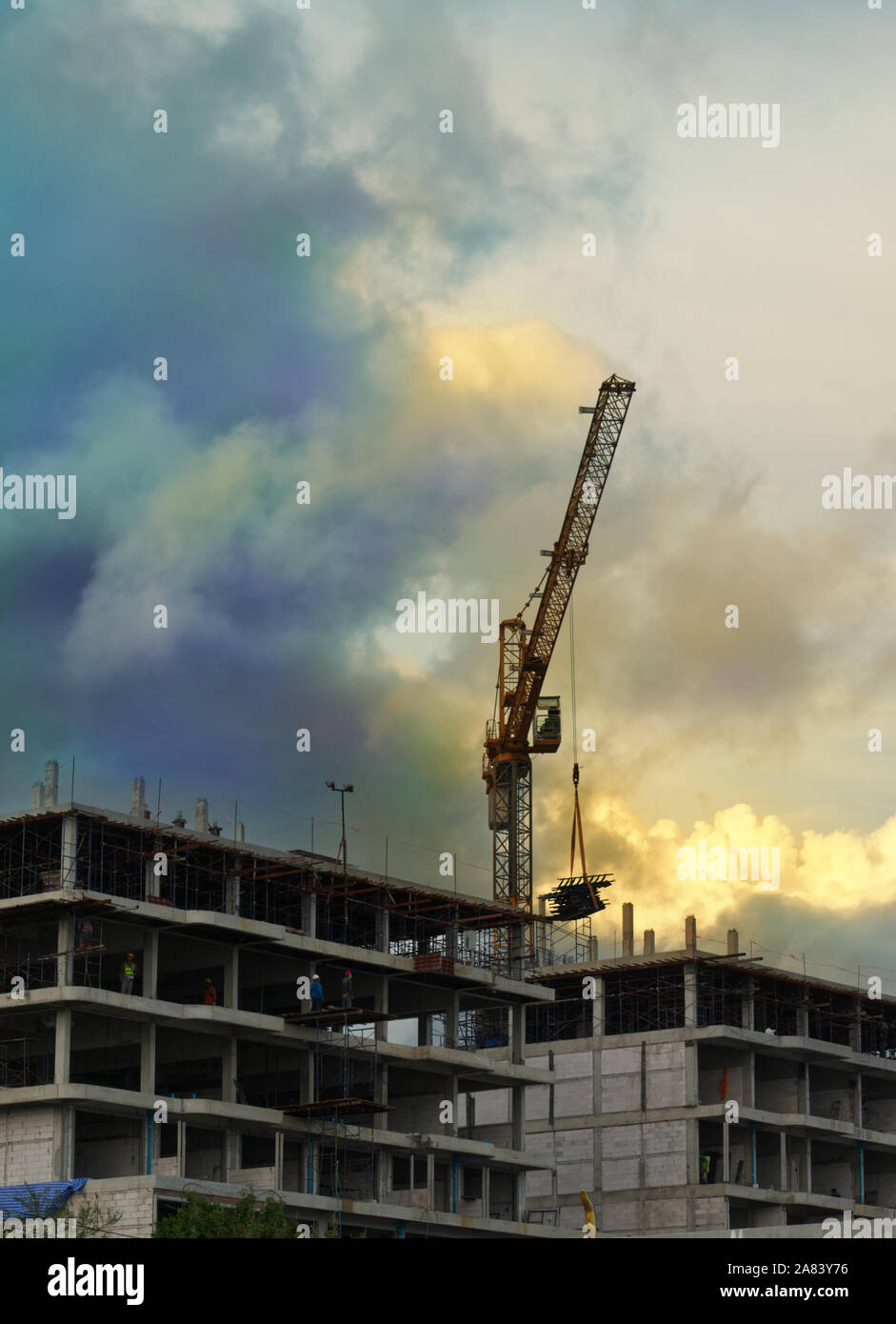 Building construction site and crane operation under evening sky Stock ...