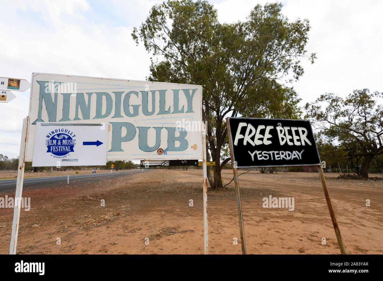 Humorous sign pointing to the iconic bush pub Nindigully Pub, built ...