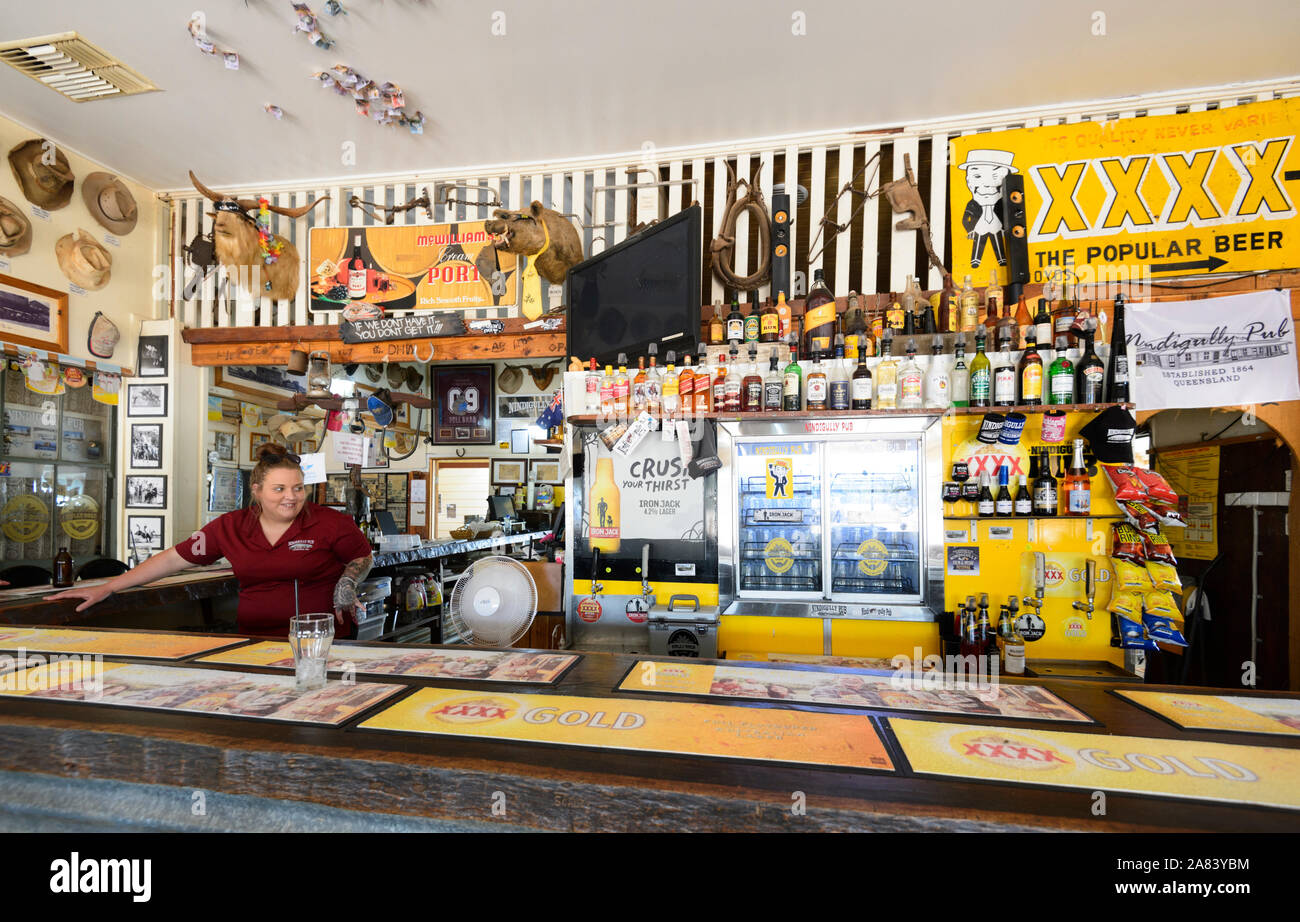 Smiling lady serving at the bar of the iconic bush pub Nindigully Pub ...