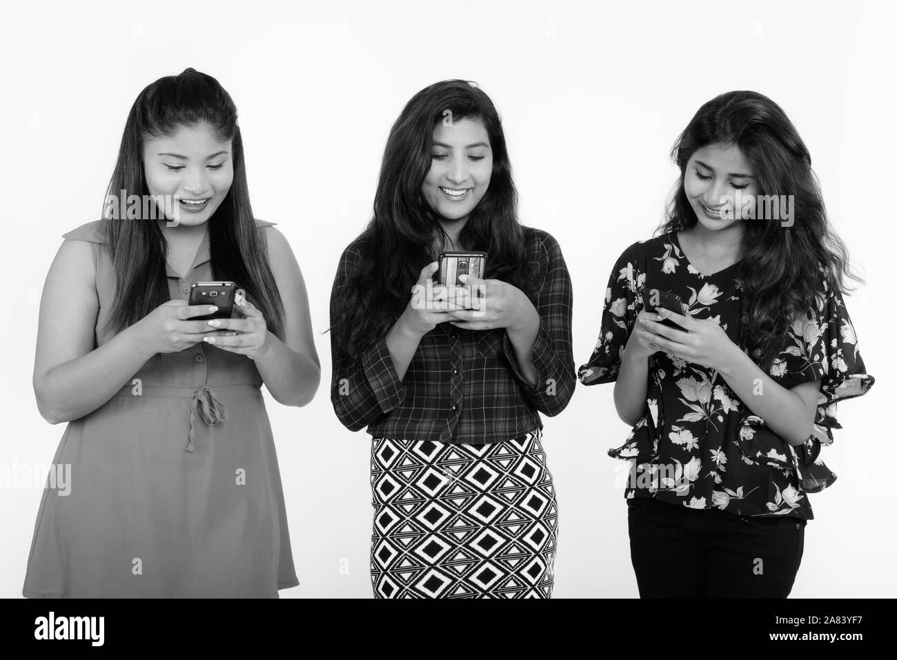 Siblings using smart phone Black and White Stock Photos & Images - Alamy