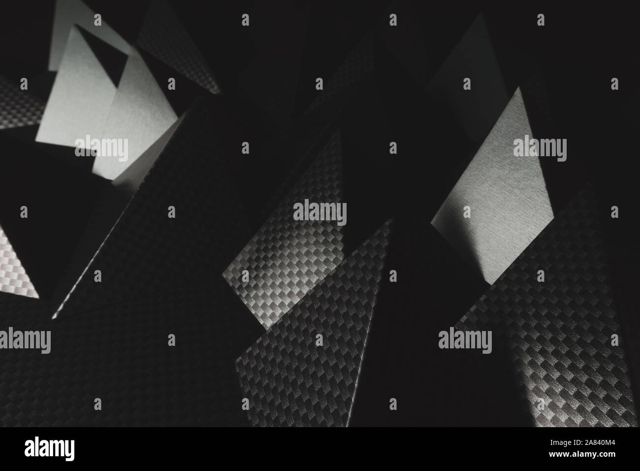 Triangular shapes of paper on dark background, abstract Stock Photo - Alamy
