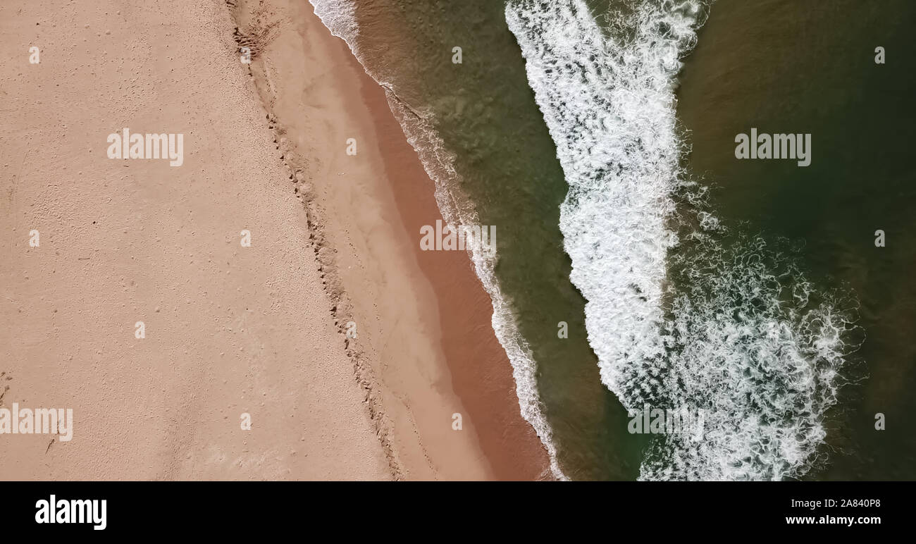 Aerial view, shot with drone on the coast of Angola, water with waves ...