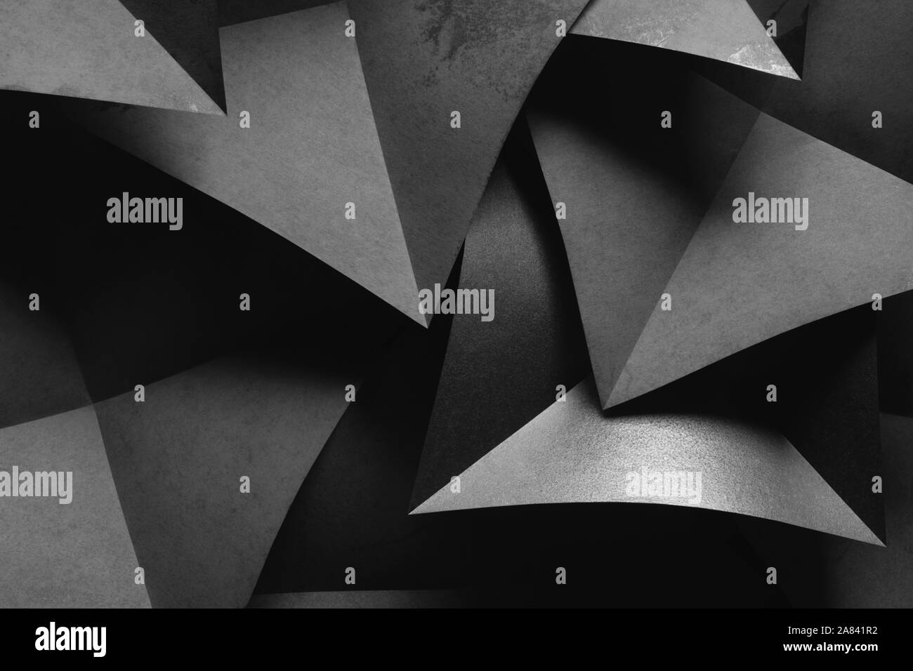 Geometric shapes of gray paper for dark background Stock Photo - Alamy