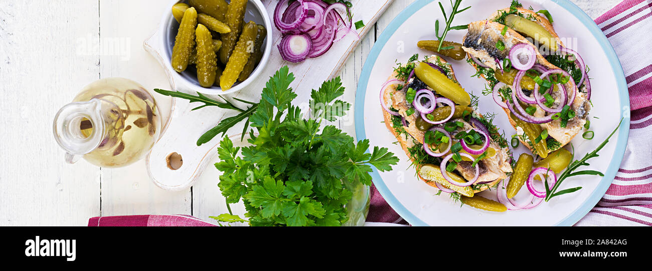 Traditional Dutch sandwich with herring and pickles cucumbers on white ...