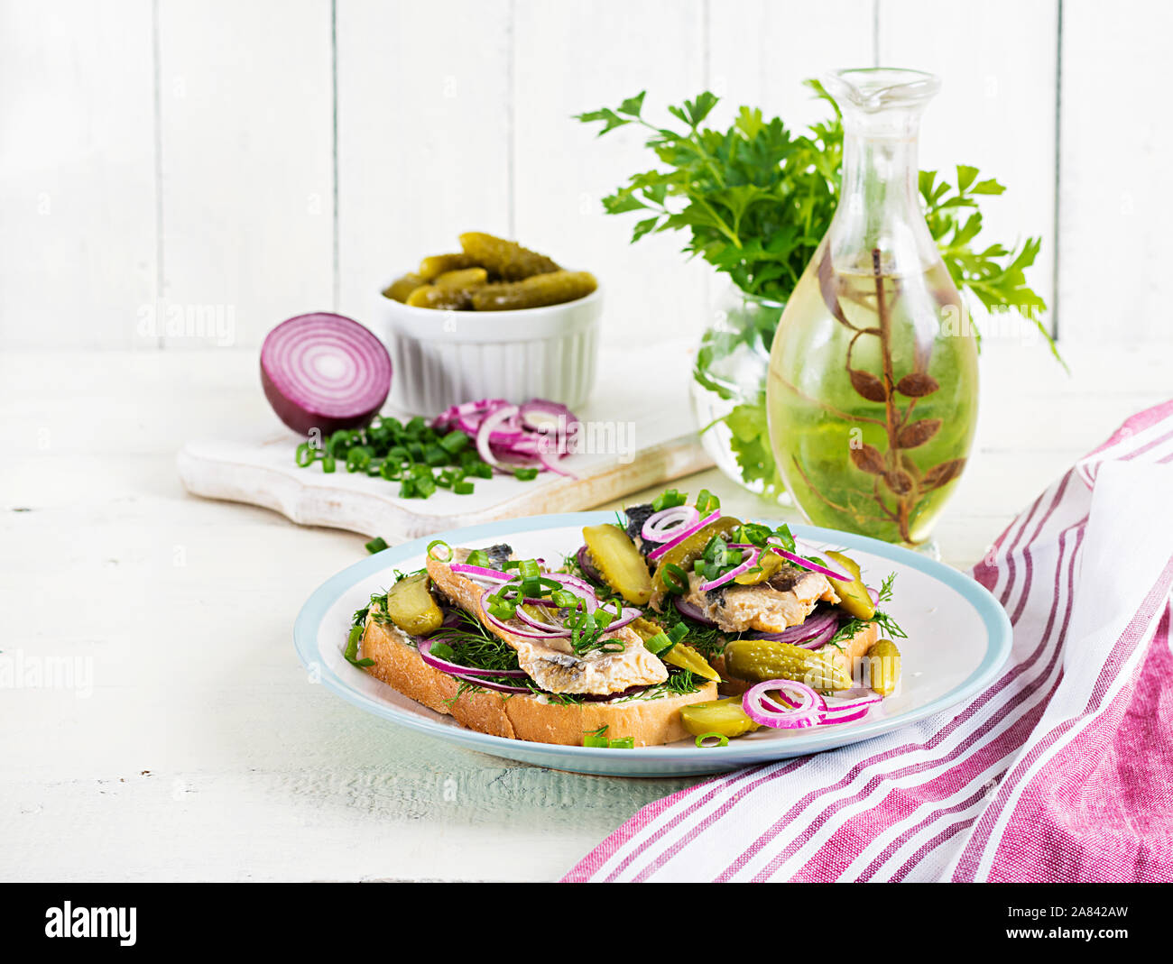 Traditional Dutch sandwich with herring and pickles cucumbers on white ...