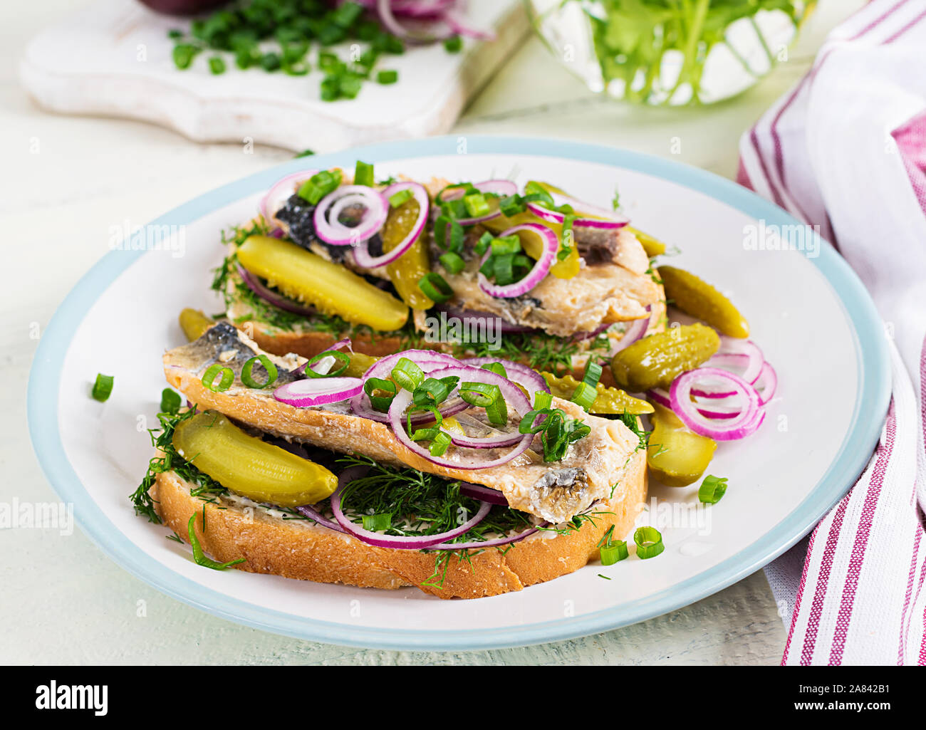 Traditional Dutch sandwich with herring and pickles cucumbers on white ...