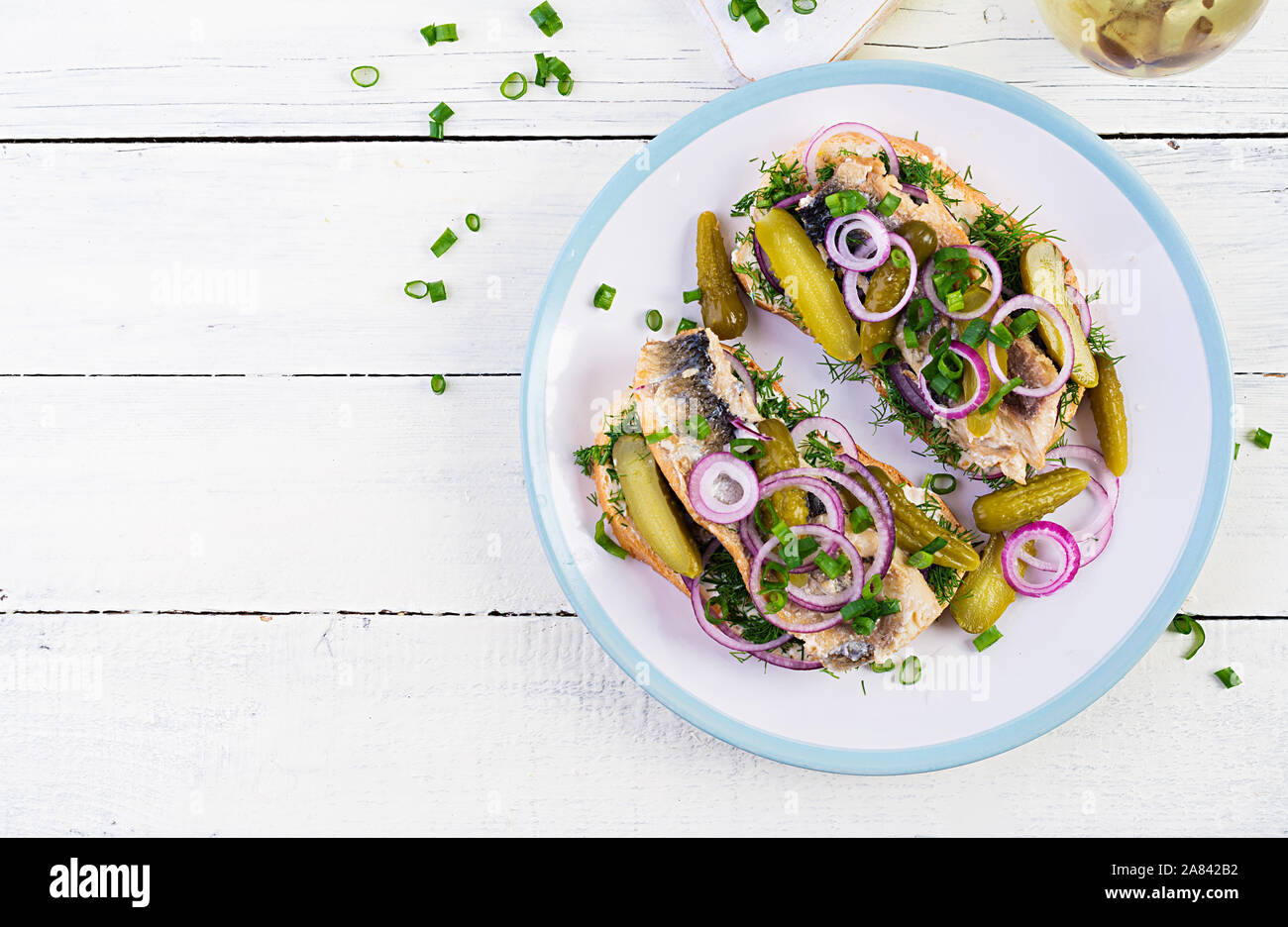 Traditional Dutch sandwich with herring and pickles cucumbers on white ...