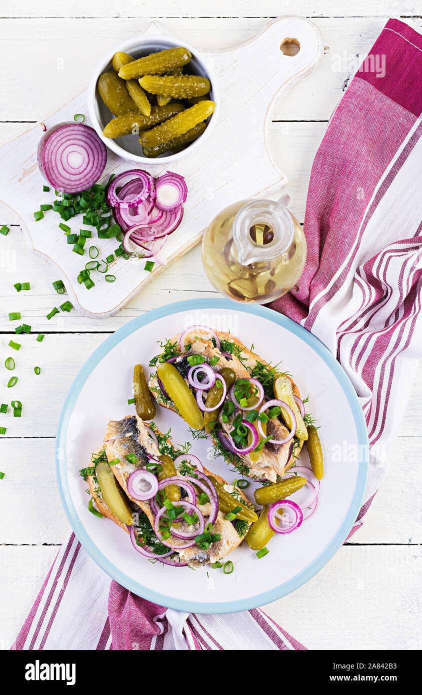 Traditional Dutch sandwich with herring and pickles cucumbers on white ...