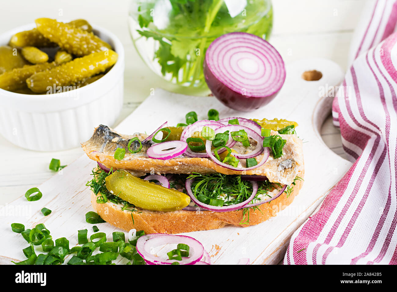 Traditional Dutch sandwich with herring and pickles cucumbers on white ...