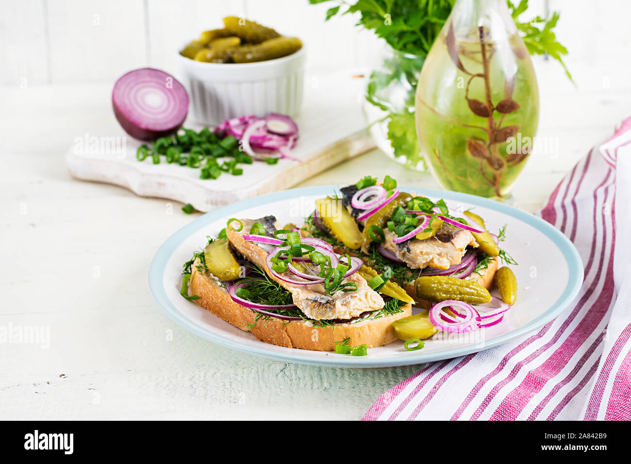 Traditional Dutch sandwich with herring and pickles cucumbers on white ...