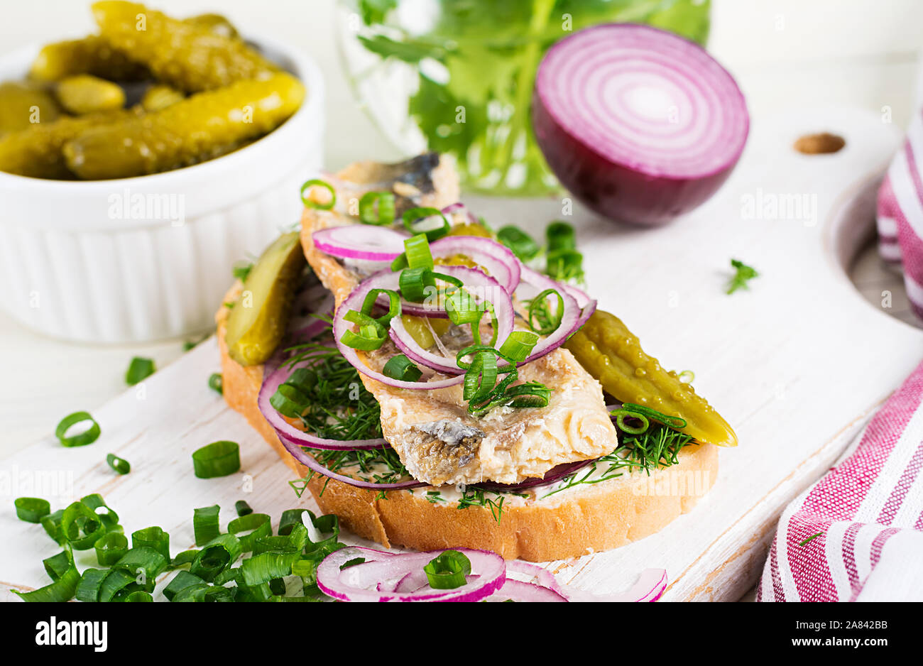 Traditional Dutch sandwich with herring and pickles cucumbers on white ...