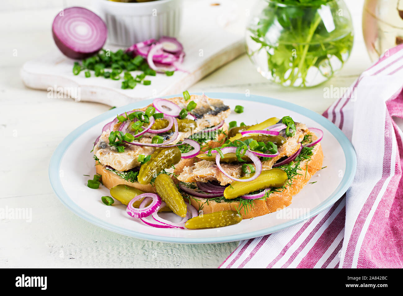 Traditional Dutch sandwich with herring and pickles cucumbers on white ...