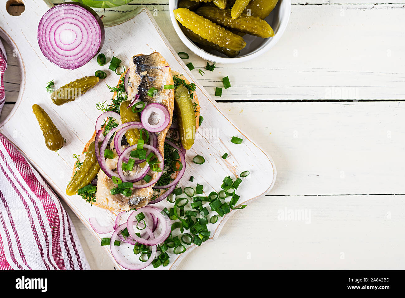 Traditional Dutch sandwich with herring and pickles cucumbers on white ...